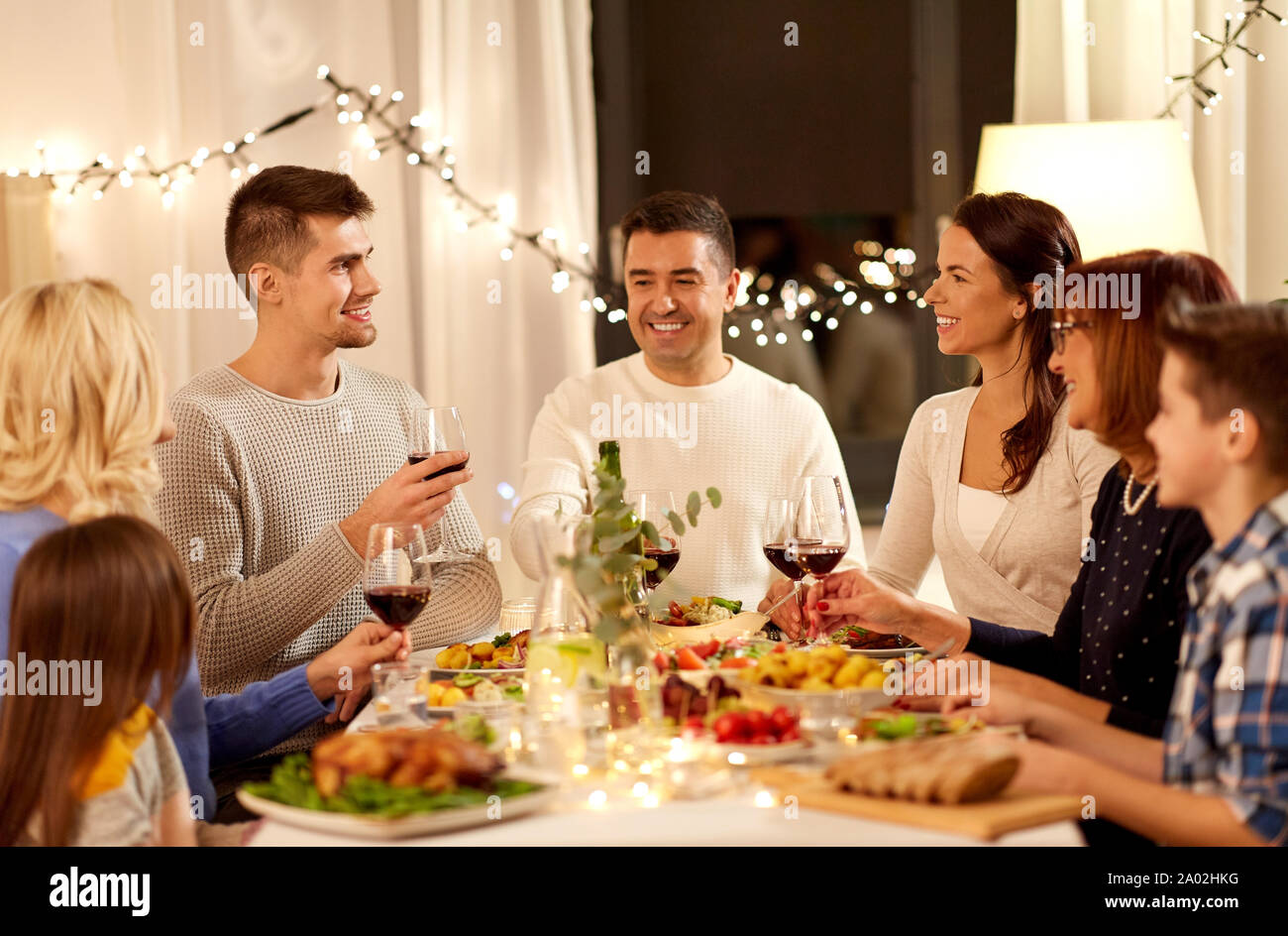 happy family having dinner party at home Stock Photo - Alamy