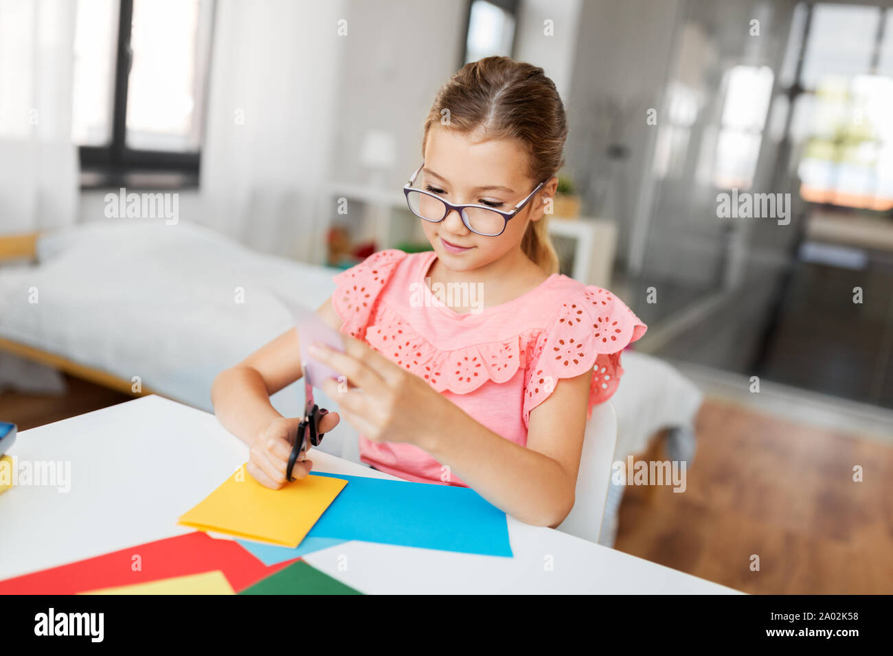 girl cutting color paper with scissors at home Stock Photo - Alamy