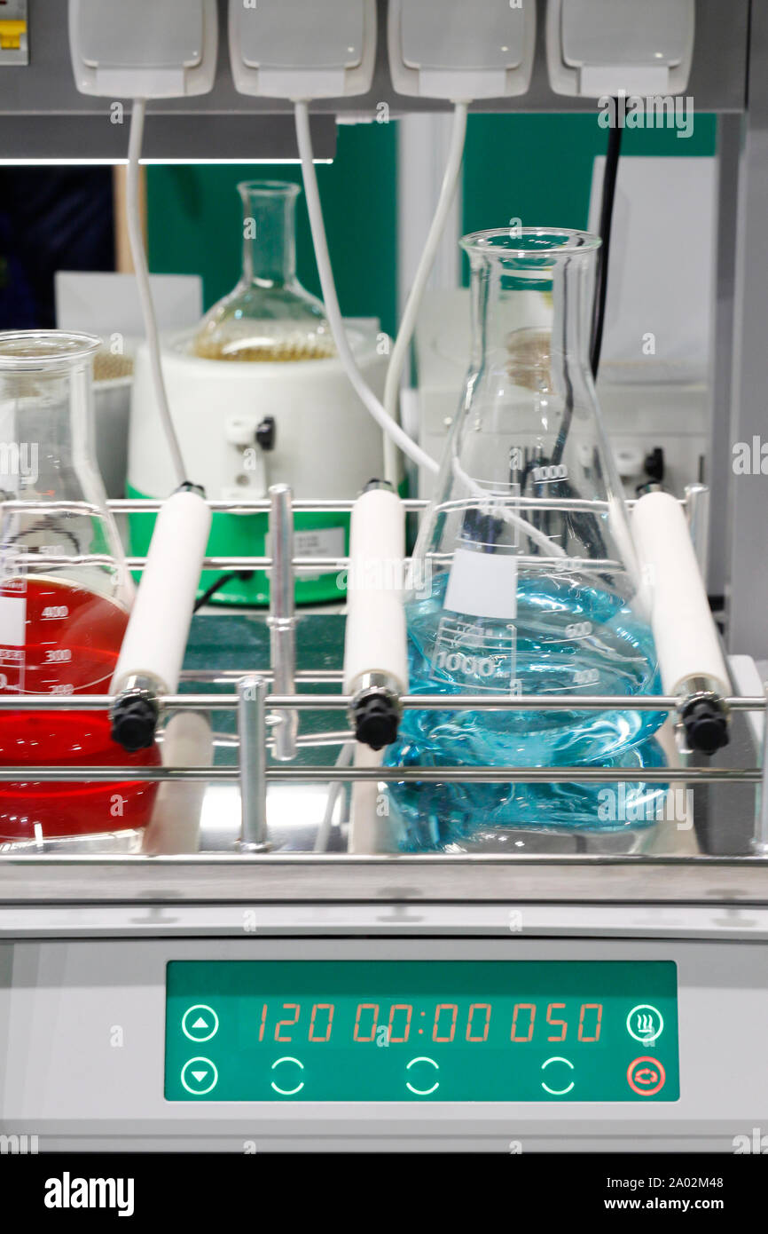 Chemical laboratory. Flasks and dishes with solutions ready for ...