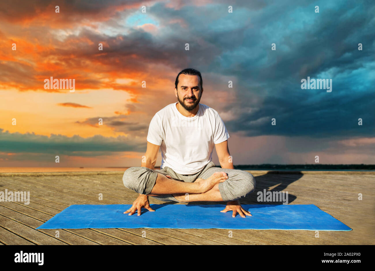 man making yoga in scale pose outdoors Stock Photo - Alamy