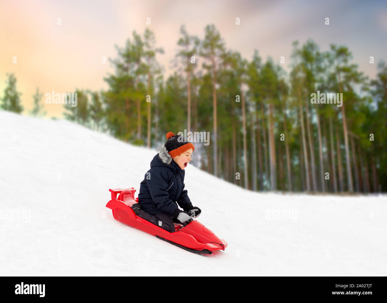 Kids Sledding Down A Hill