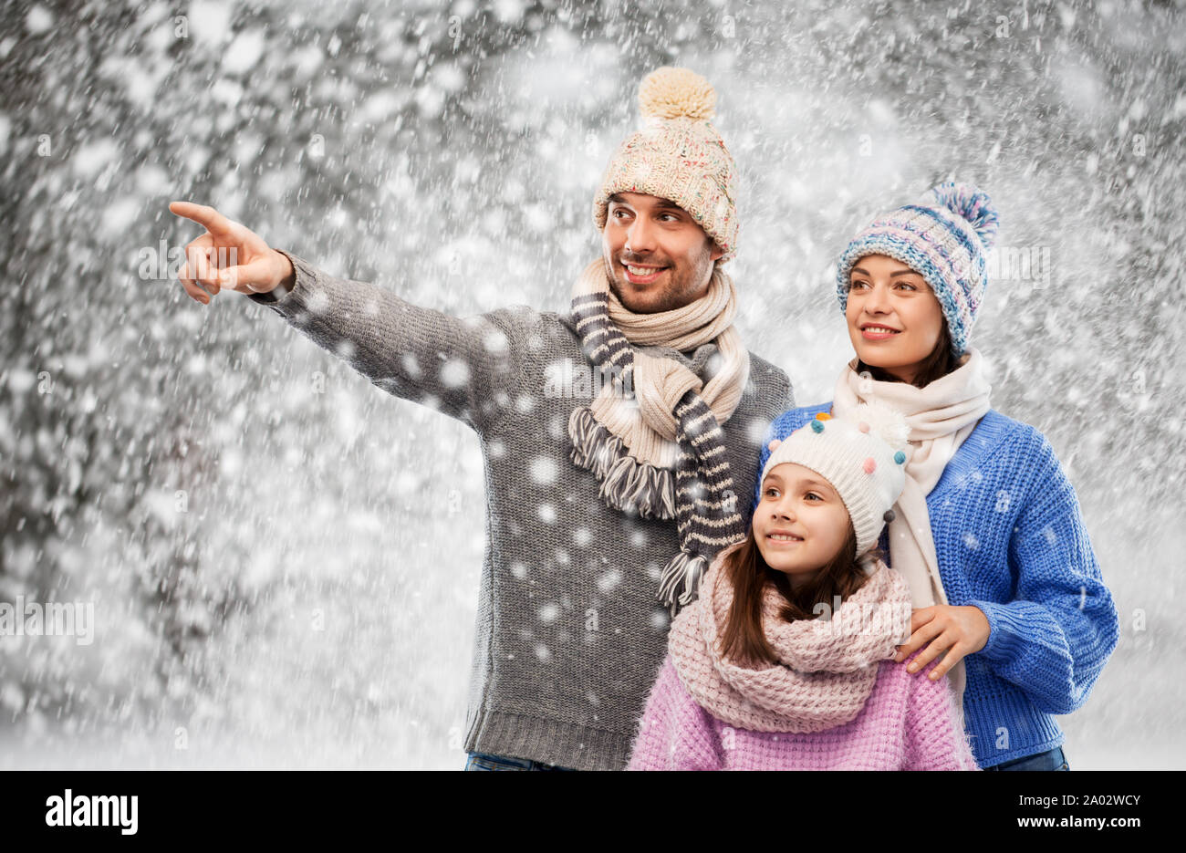 happy family in winter clothes on snow background Stock Photo - Alamy