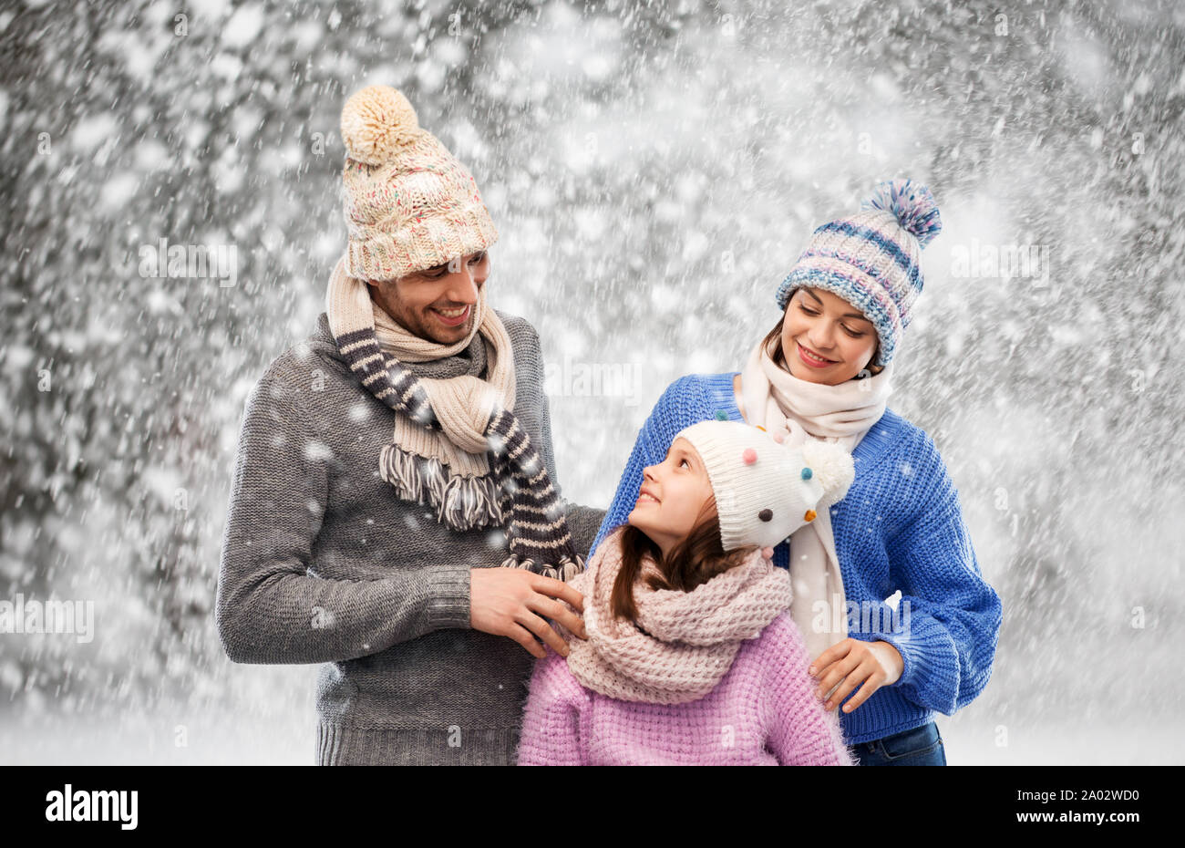 happy family in winter clothes on snow background Stock Photo - Alamy