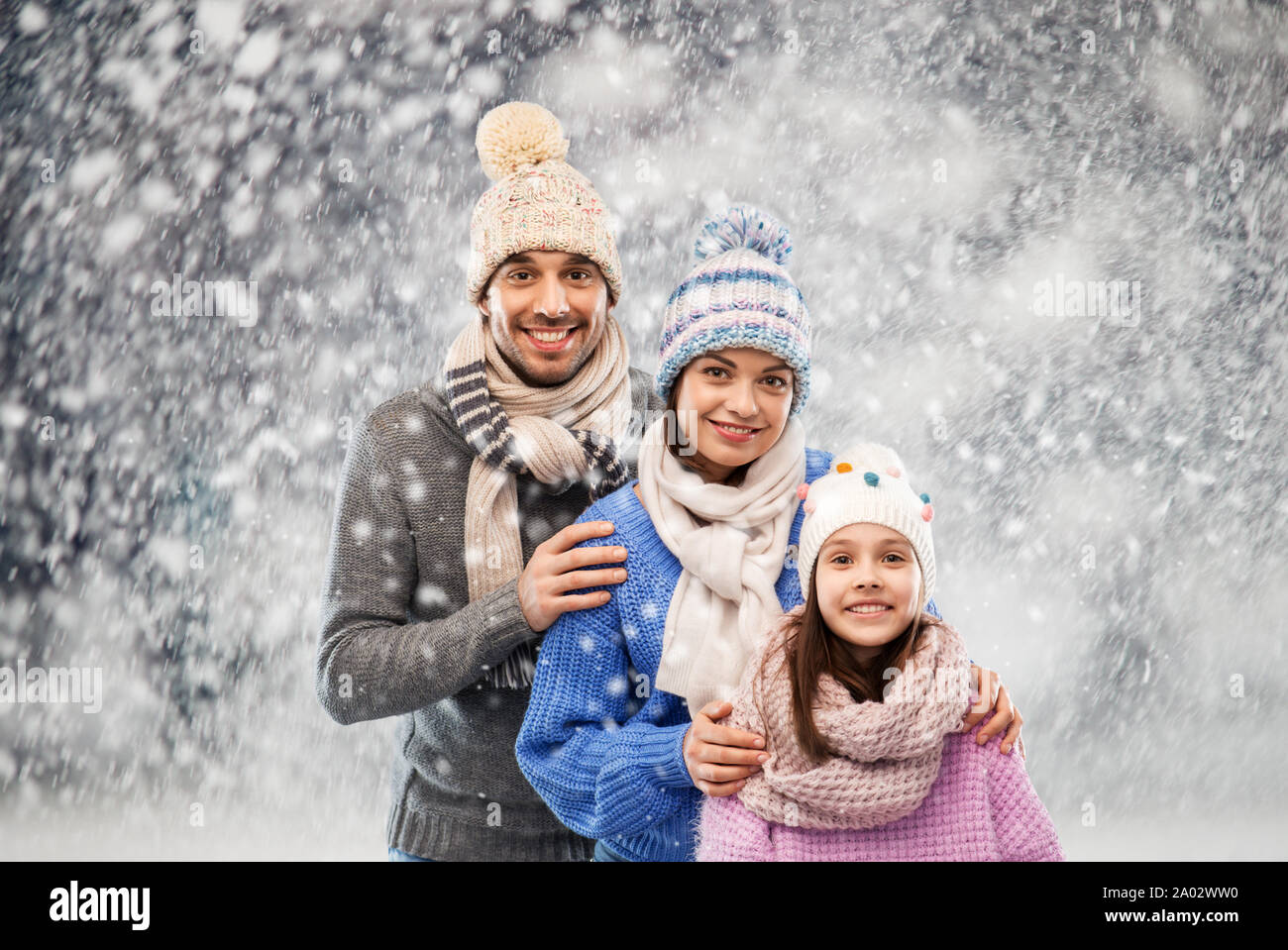 happy family in winter clothes on snow background Stock Photo - Alamy