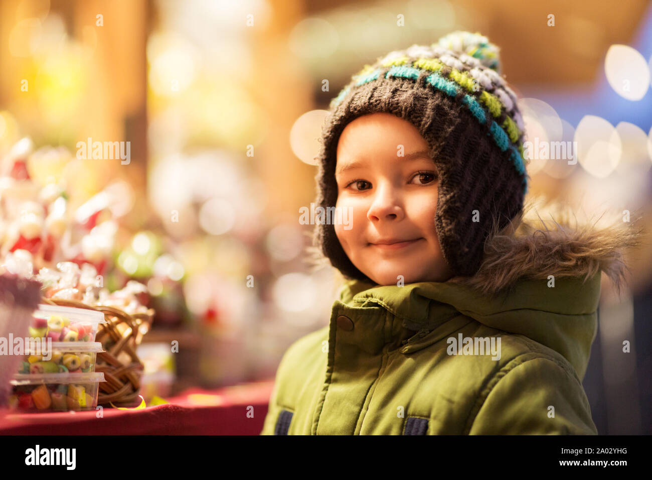 happy little boy at christmas market candy shop Stock Photo - Alamy