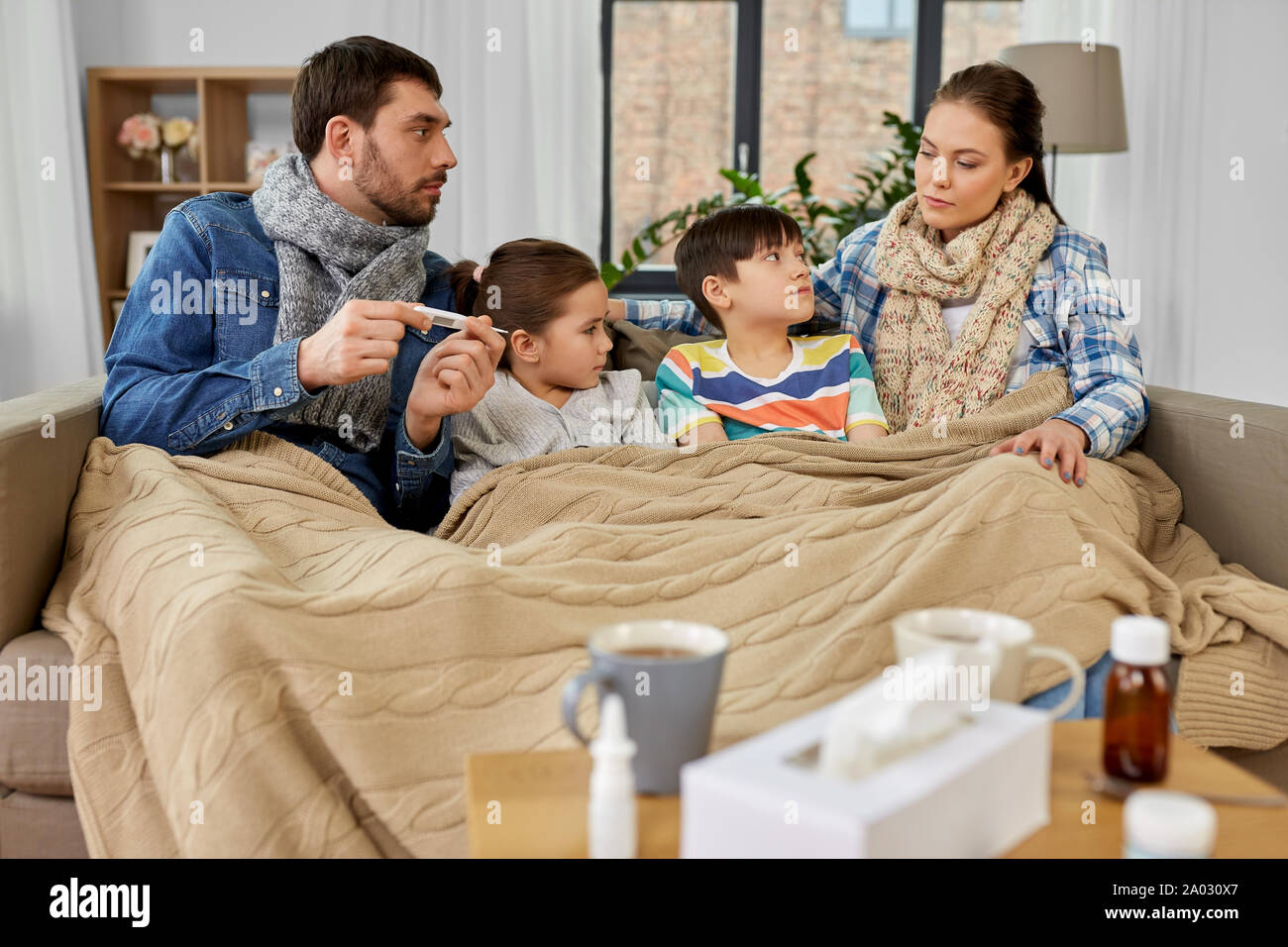 family with ill children having fever at home Stock Photo - Alamy