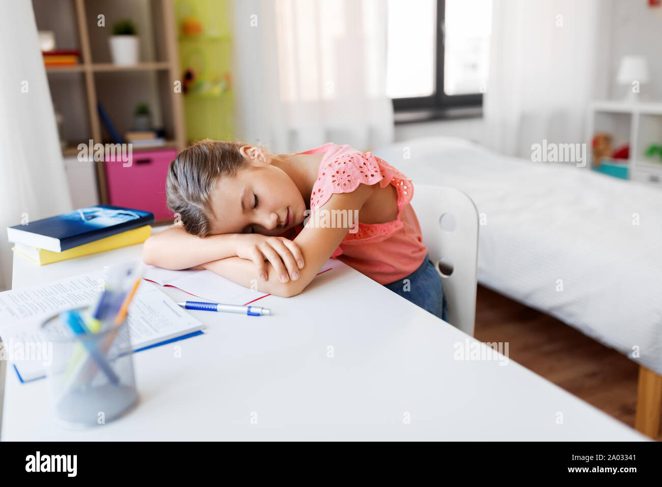 tired student girl sleeping on table at home Stock Photo - Alamy