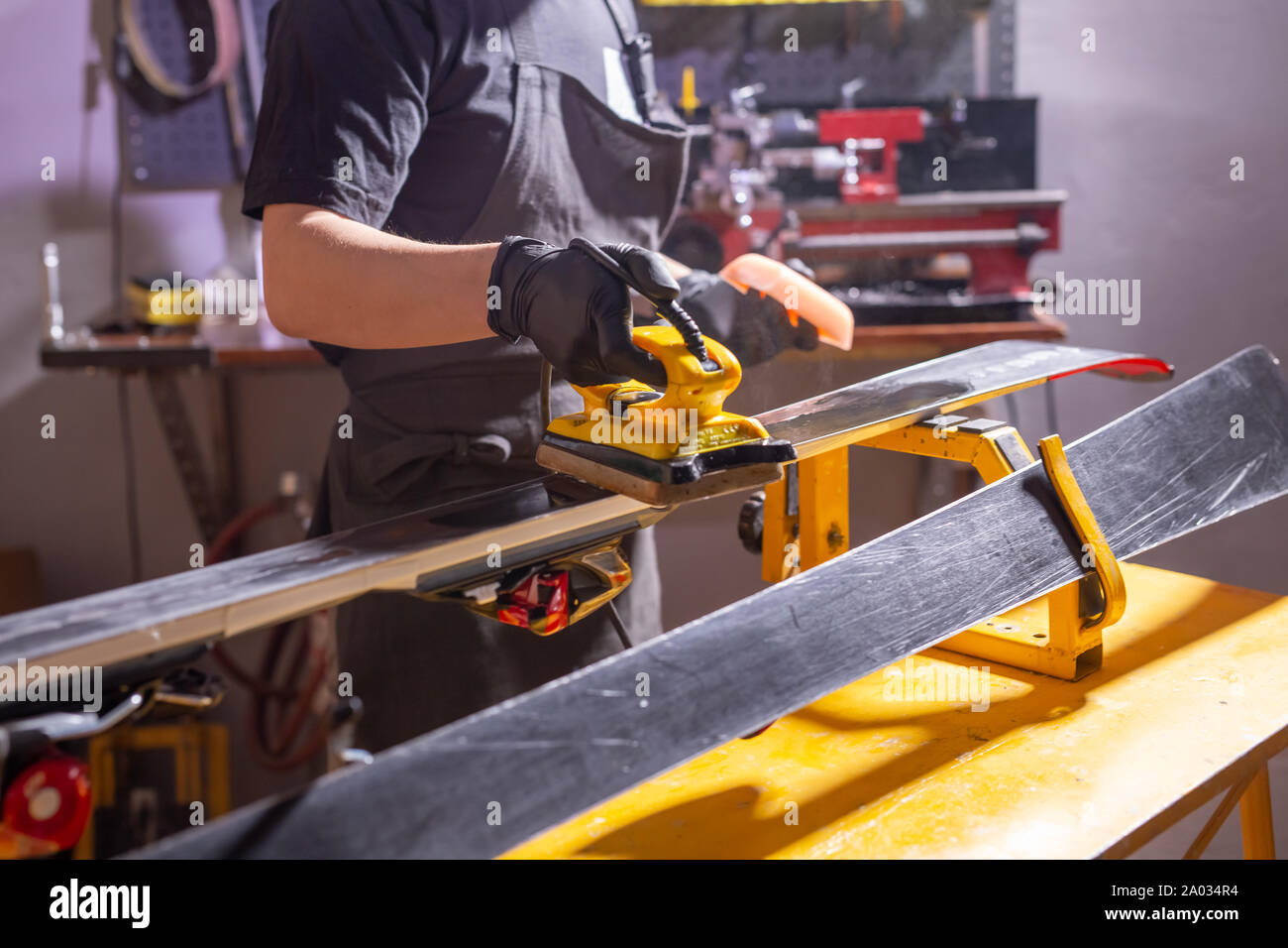 Repair, people concept - mechanic, man is rubbing a ski Stock Photo - Alamy