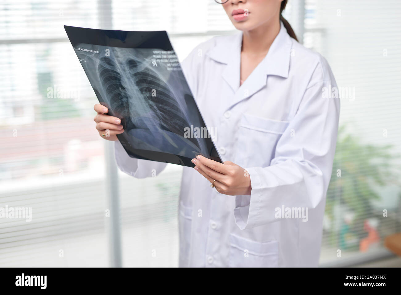 Confident female doctor examining accurately a rib cage x-ray Stock ...