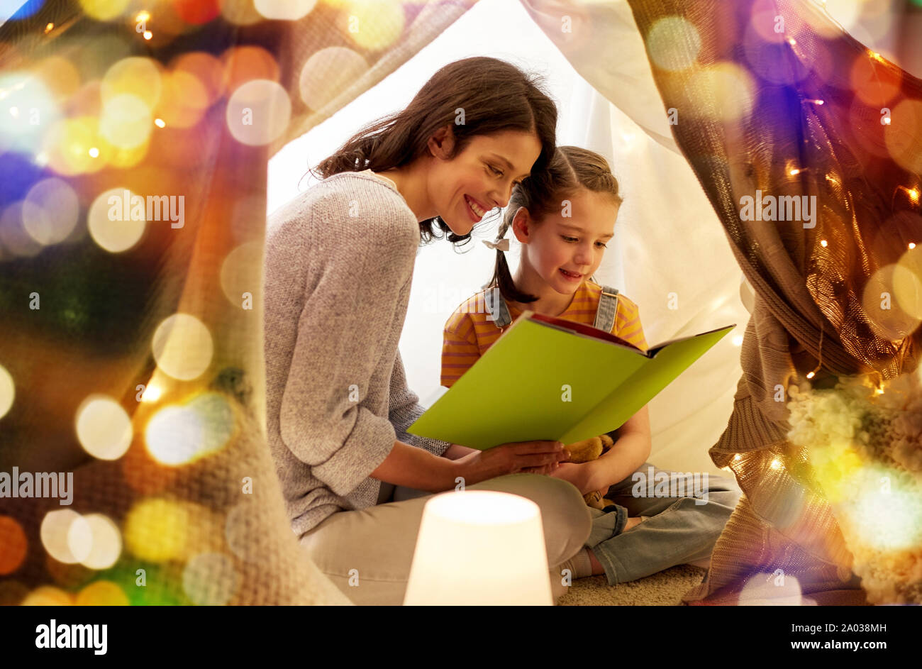 happy family reading book in kids tent at home Stock Photo - Alamy