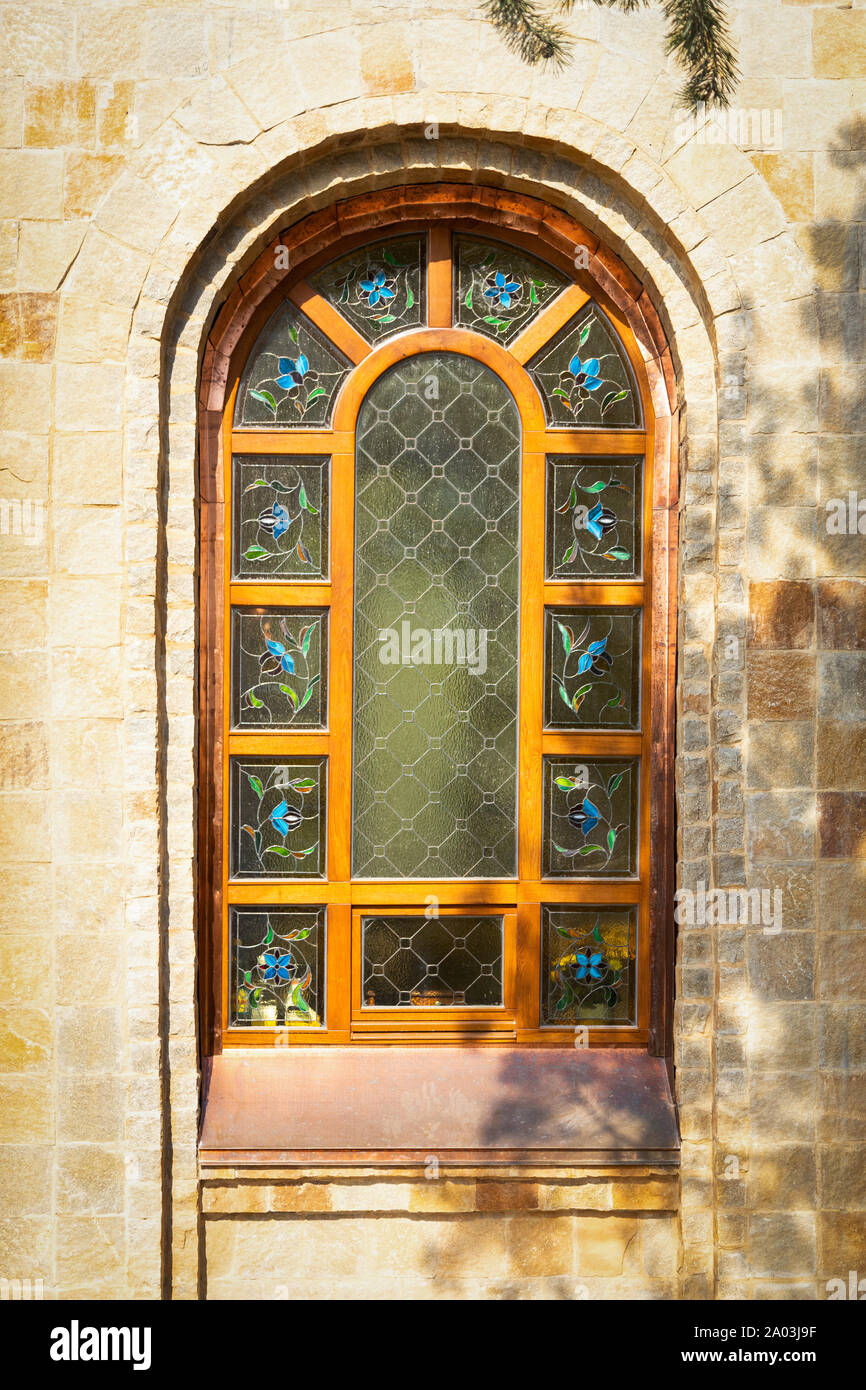 Russian architecture. Close-up old beautiful stained glass window with ...