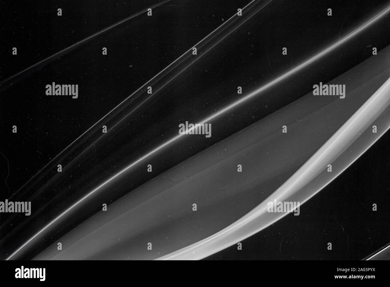 A real wisp of white smoke on a black background with grain, dust and ...