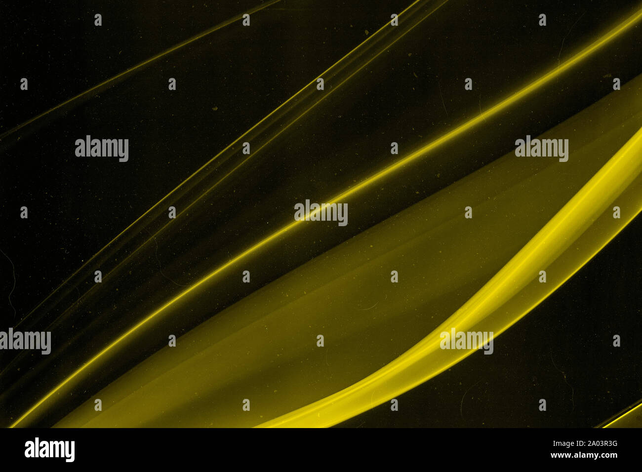 A real wisp of yellow smoke on a black background with grain, dust and ...