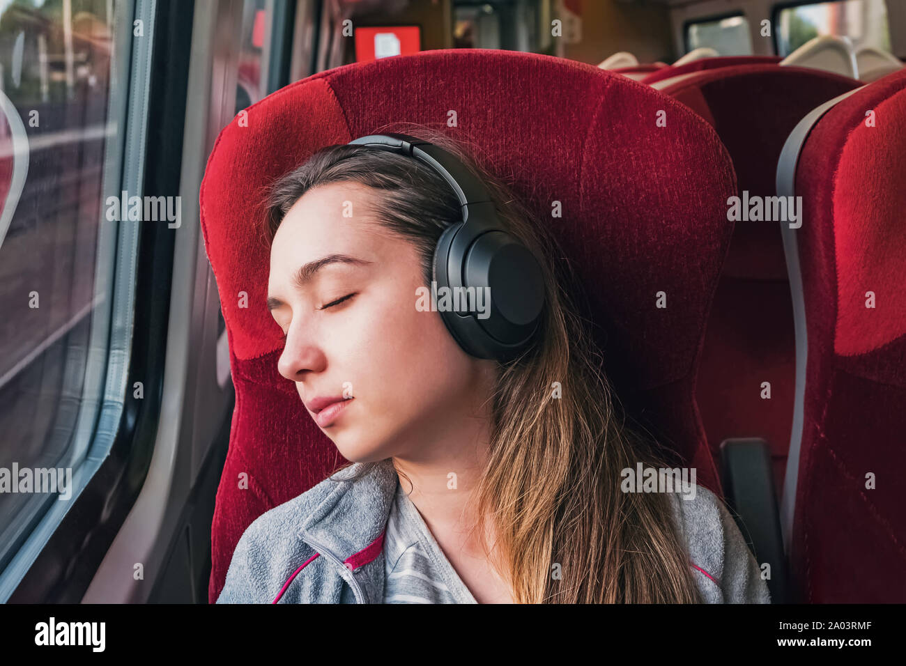 Young Woman Relaxing Or Sleeping While Listening Music In Headphones