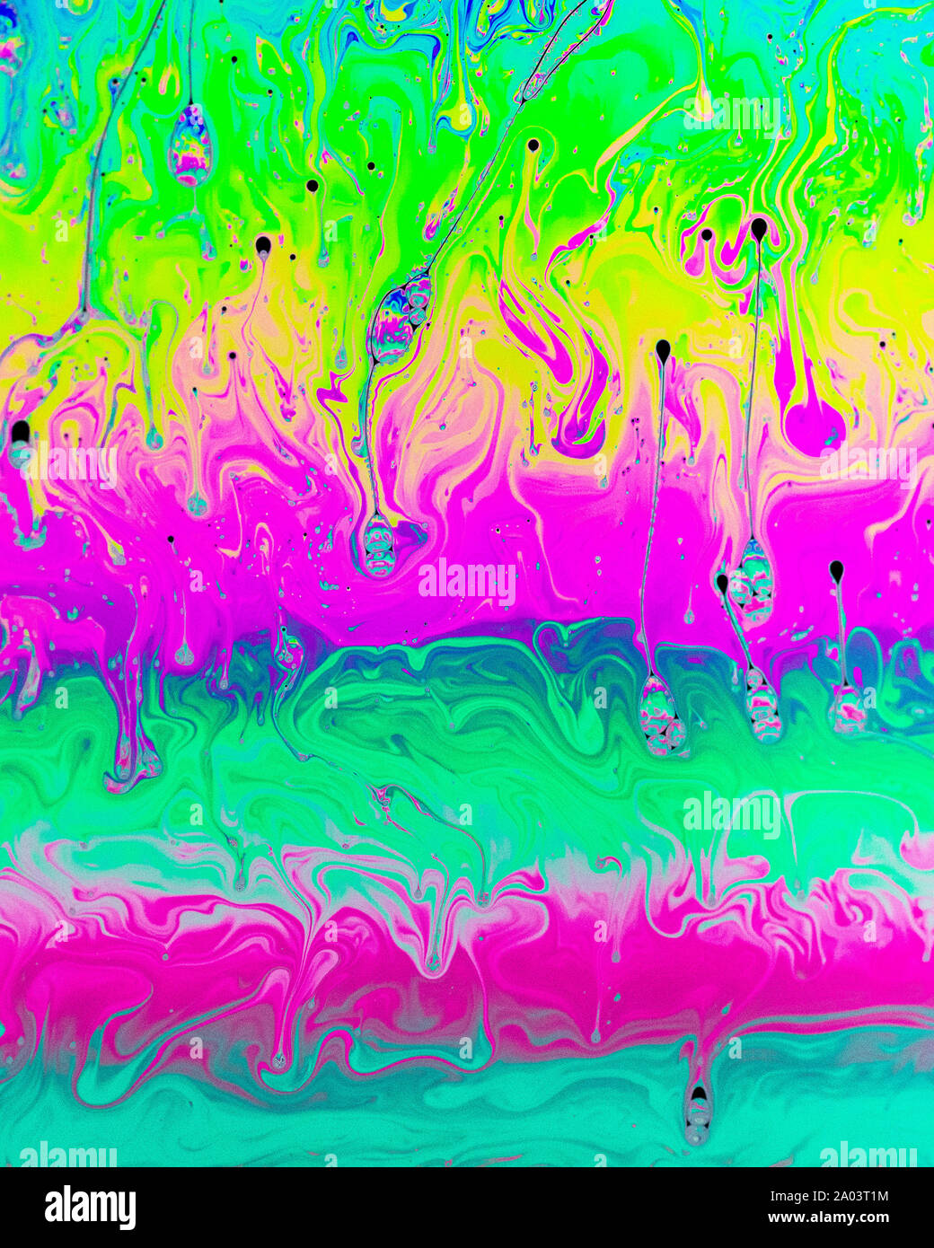 A creative abstract swirling liquid rainbow of colours that looks like ...
