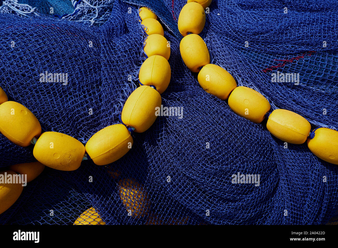 Deep sea blue fishing nets with yellow floats Stock Photo - Alamy