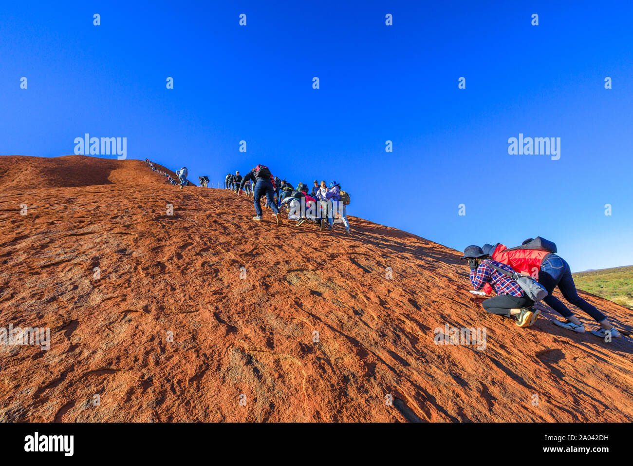Uluru, Northern Territory, Australia - Aug 23, 2019: many people climb ...