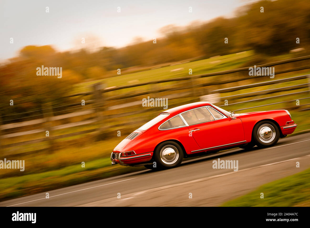 red Porsche 911 driving at speed Stock Photo - Alamy