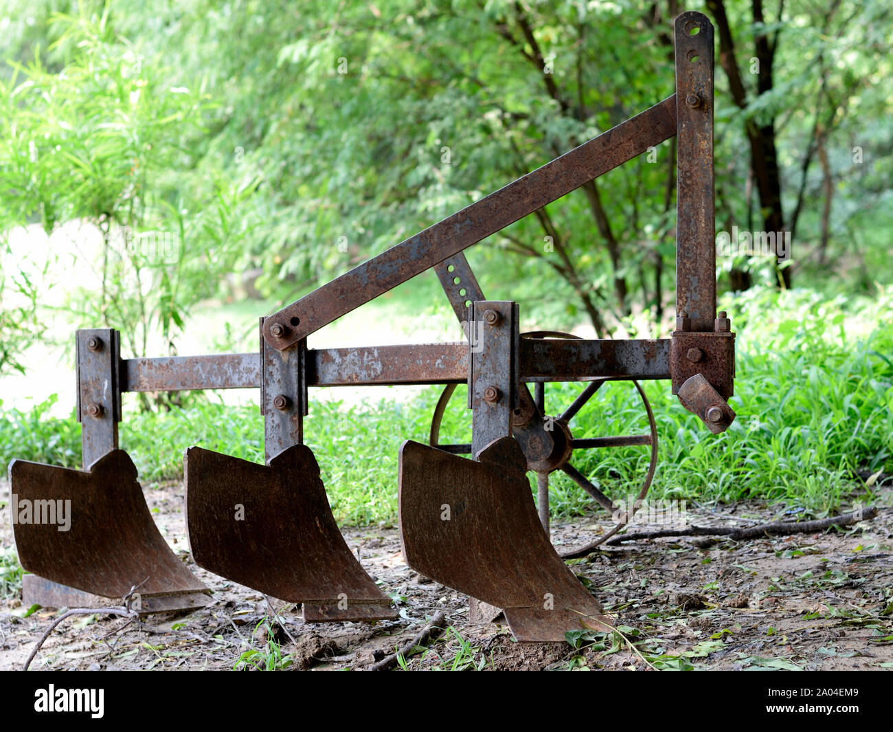 an old abundant tractor plough lying on the ground Stock Photo - Alamy
