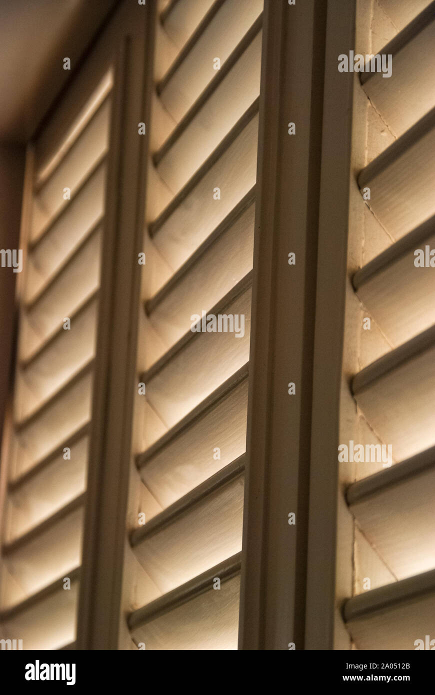 Soft light through wooden blind shutters in perspective position ...
