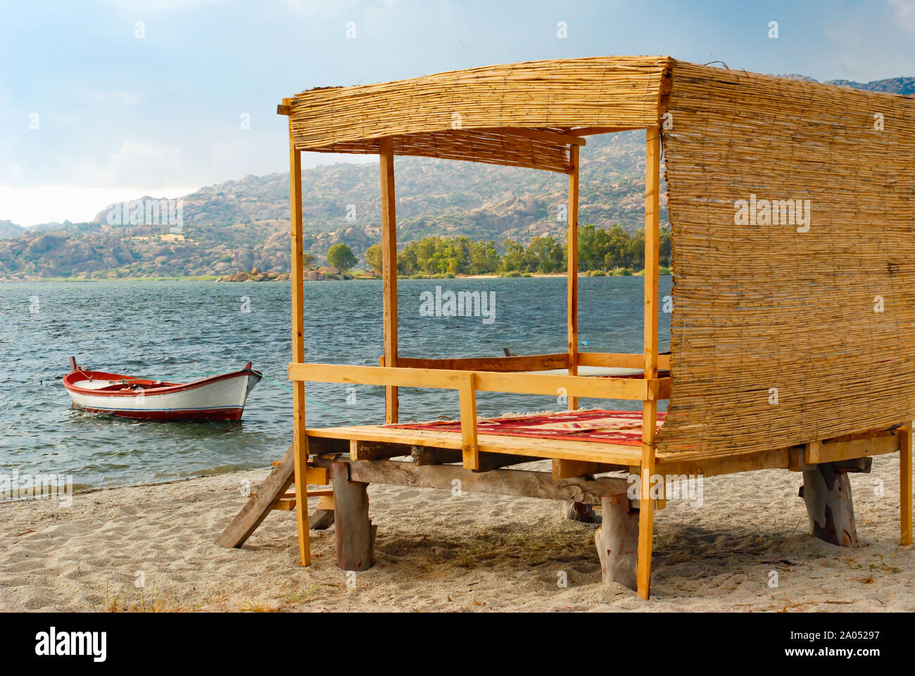 Wooden platform and fishing boats tied to the bay of the sea coast ...