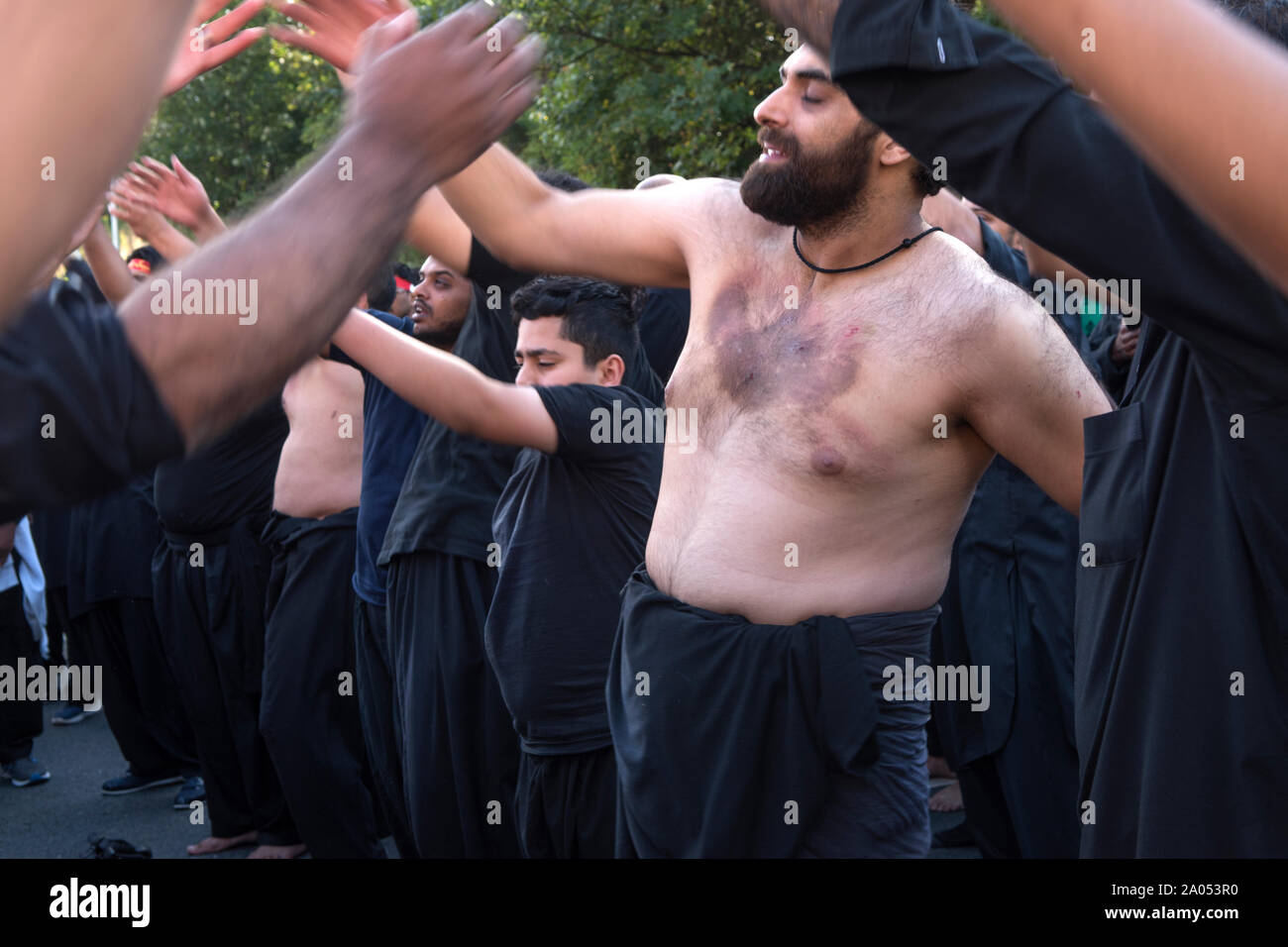 Ashura Ritual Men beat their chest in ritual self flagellation Muslim ...