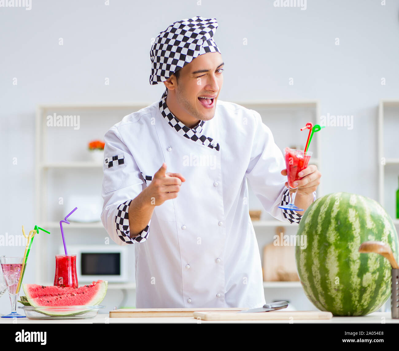 The male cook with watermelon in kitchen Stock Photo - Alamy