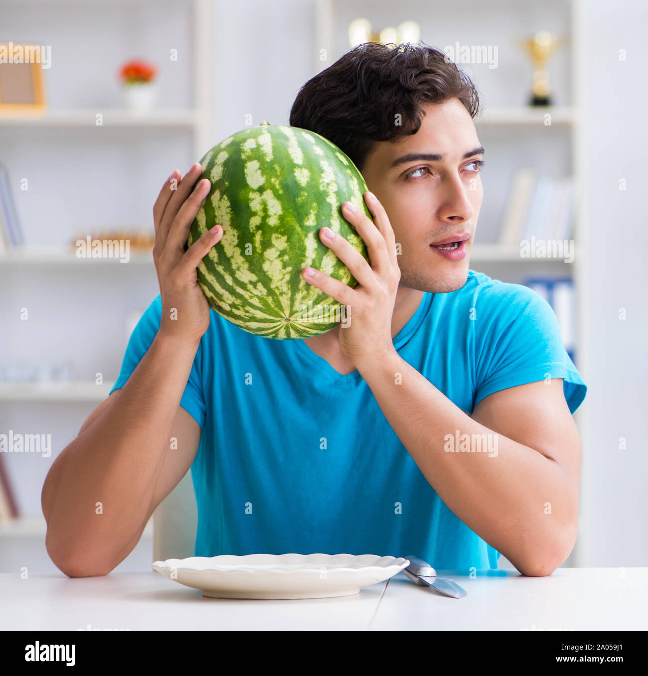 The man eating watermelon at home Stock Photo - Alamy