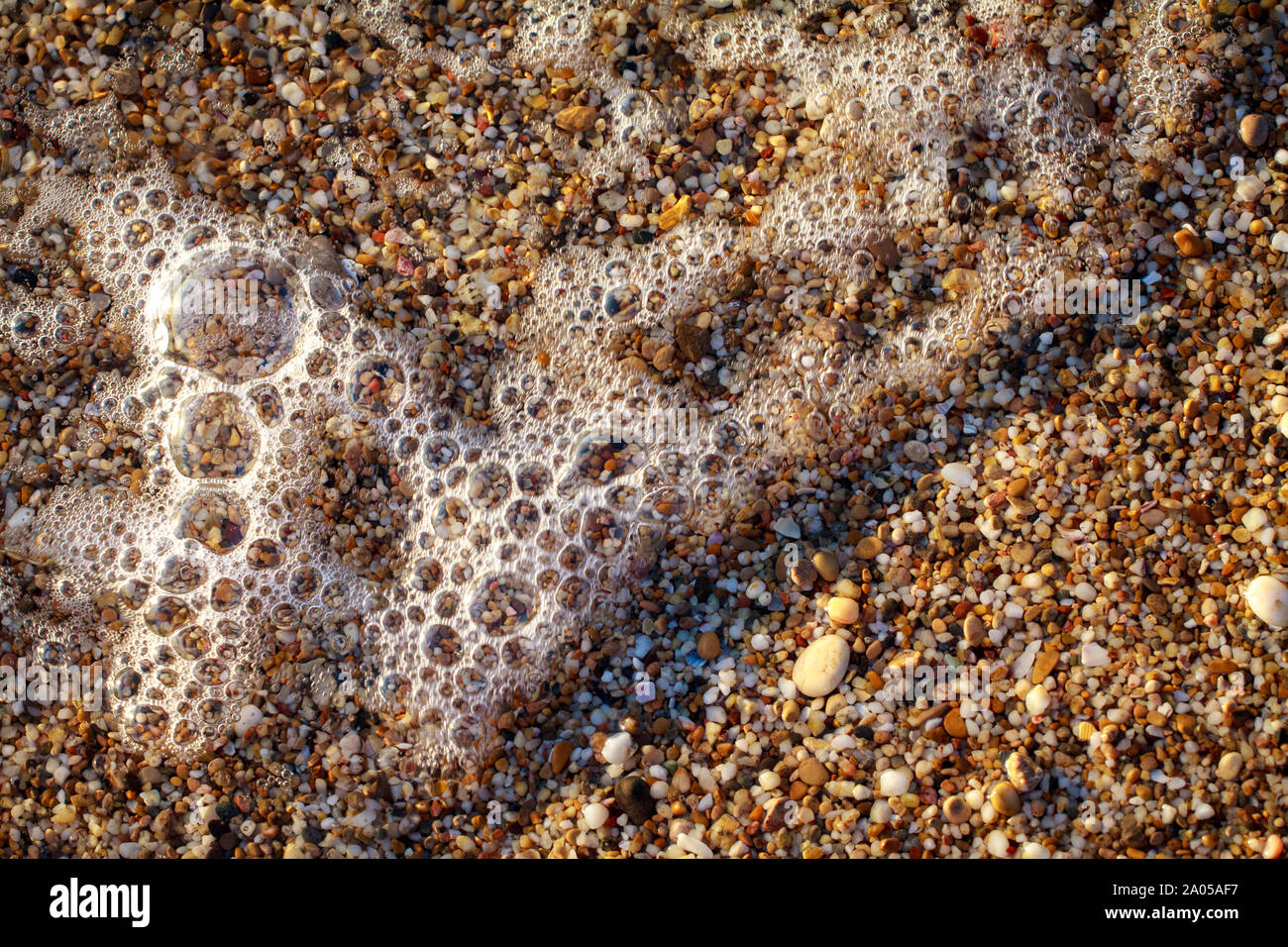 sea pebbles colored granite on the beach background stones. The shore ...