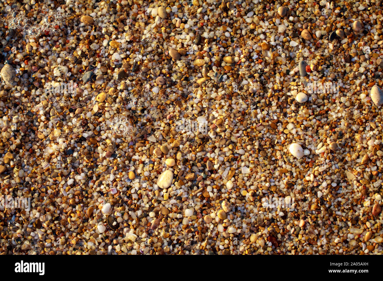 sea pebbles colored granite on the beach background stones. The shore ...