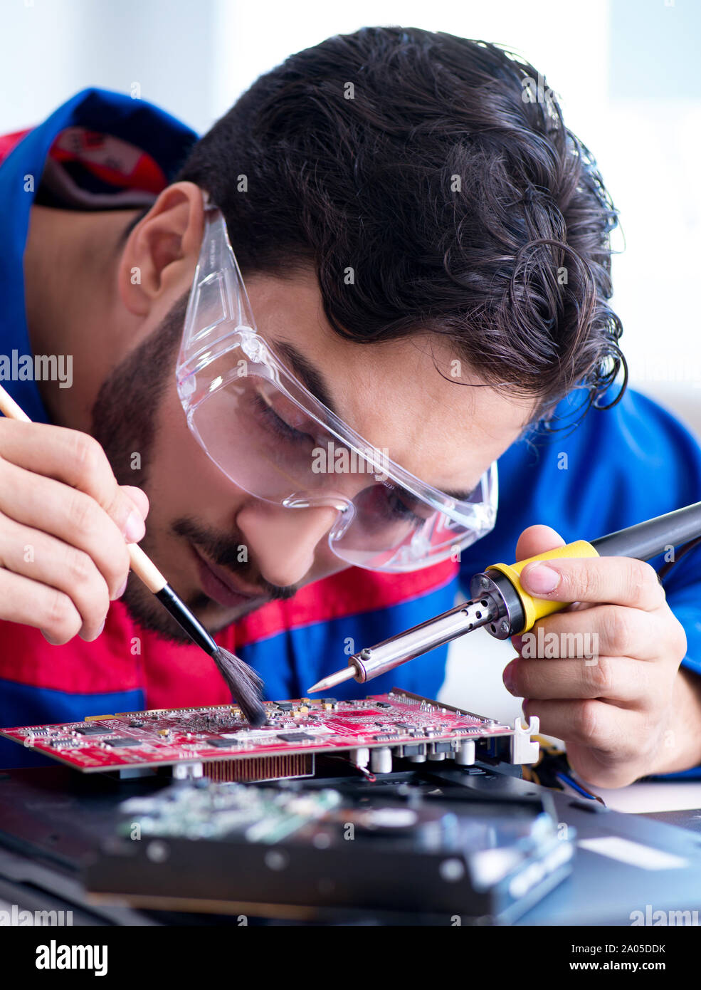 Repairman working in technical support fixing computer laptop ...