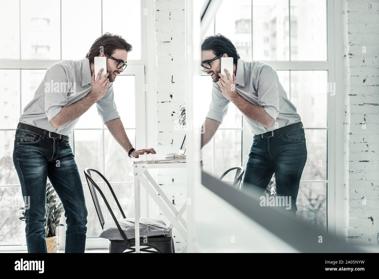Cheerful young office worker having pause during work Stock Photo - Alamy