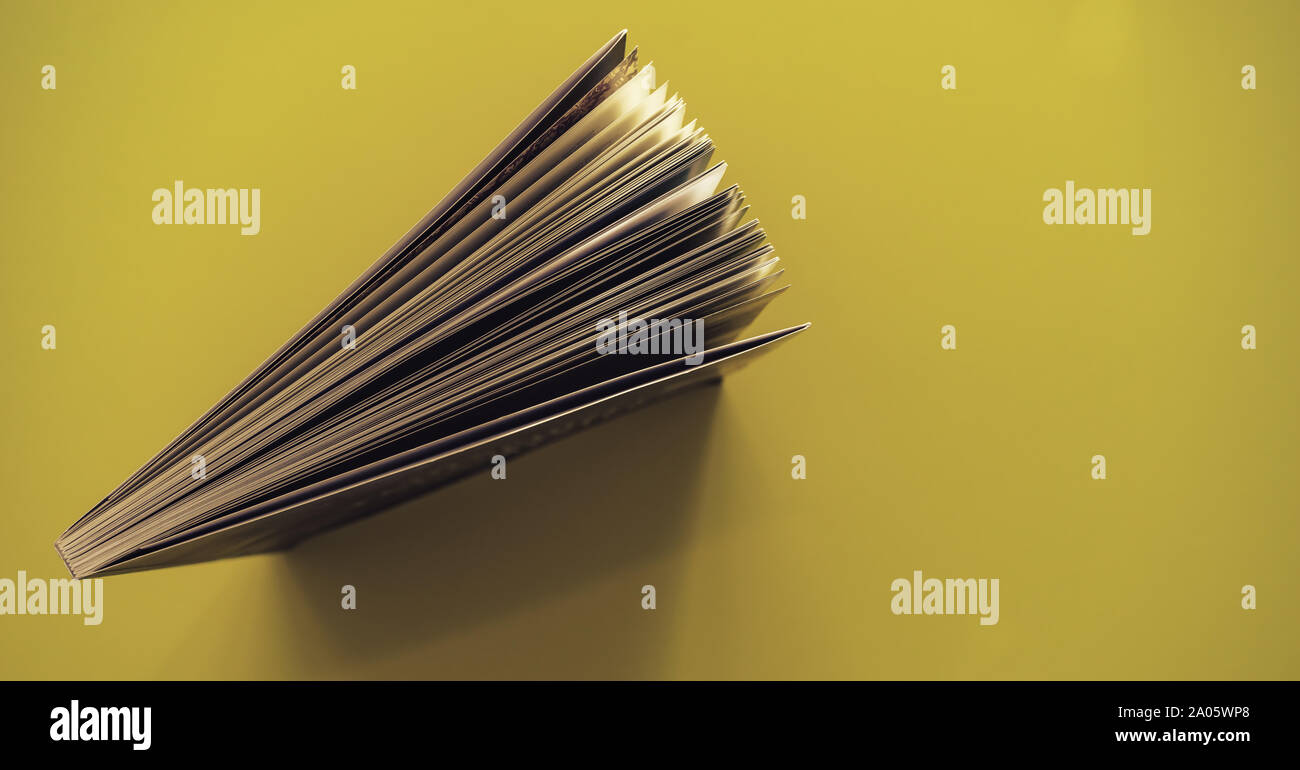 Beautiful book top view on a yellow background table Stock Photo - Alamy