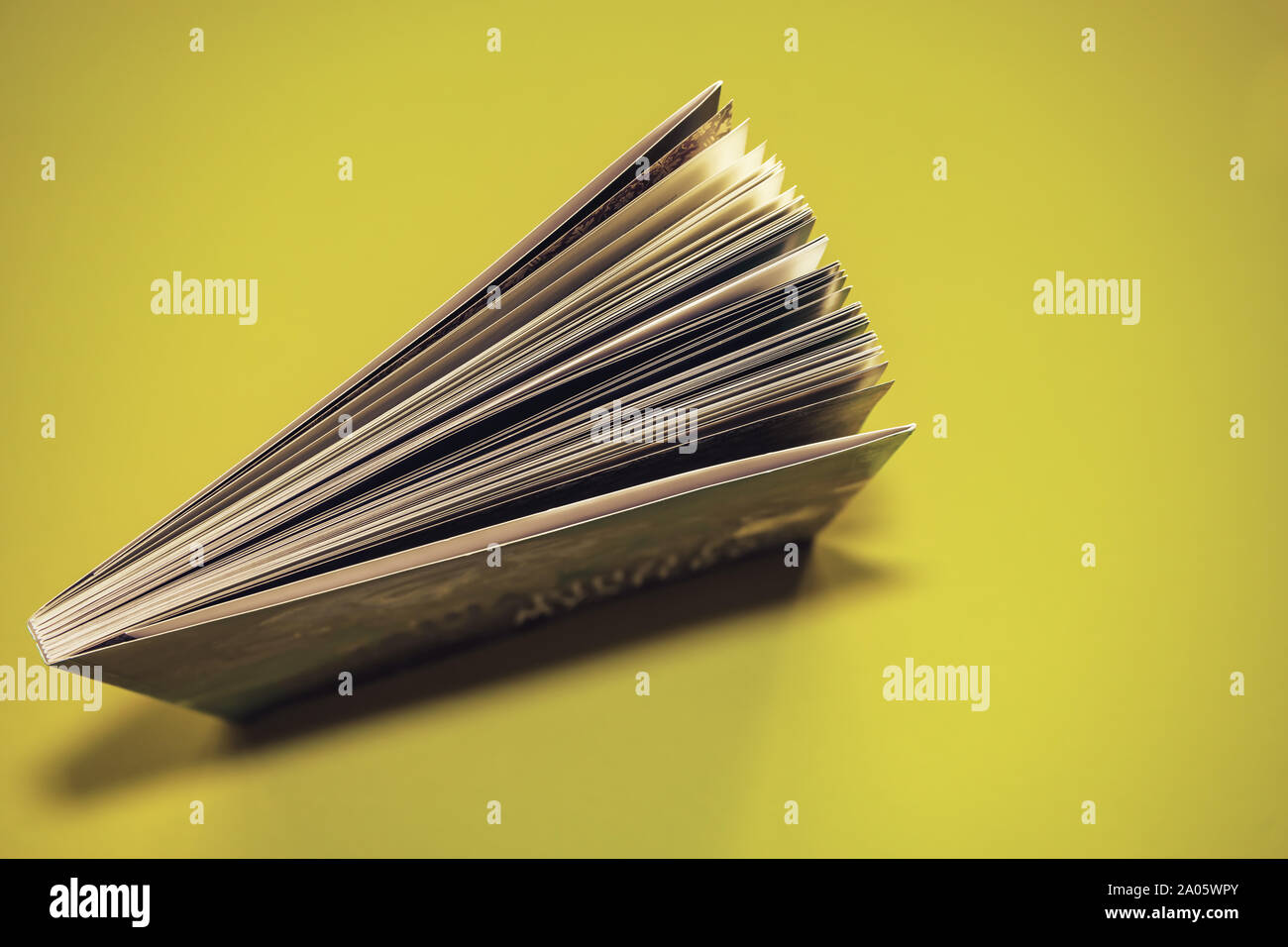 Beautiful book top view on a yellow background table Stock Photo - Alamy