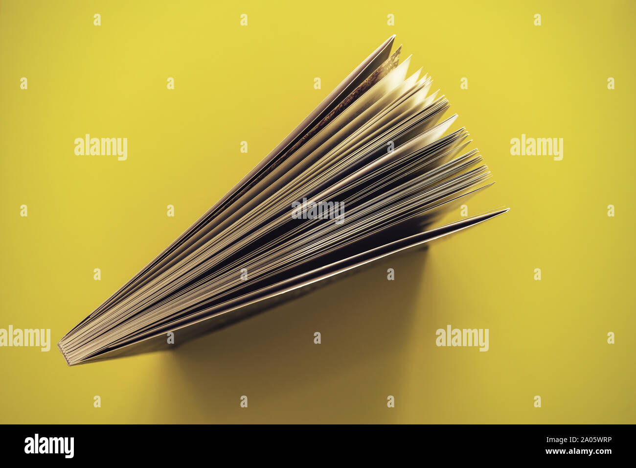 Beautiful book top view on a yellow background table Stock Photo - Alamy