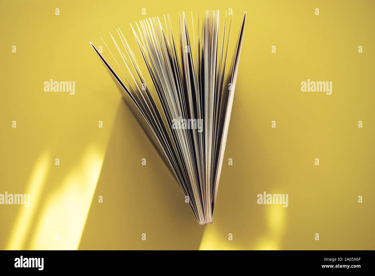 Beautiful book top view on a yellow background table Stock Photo - Alamy