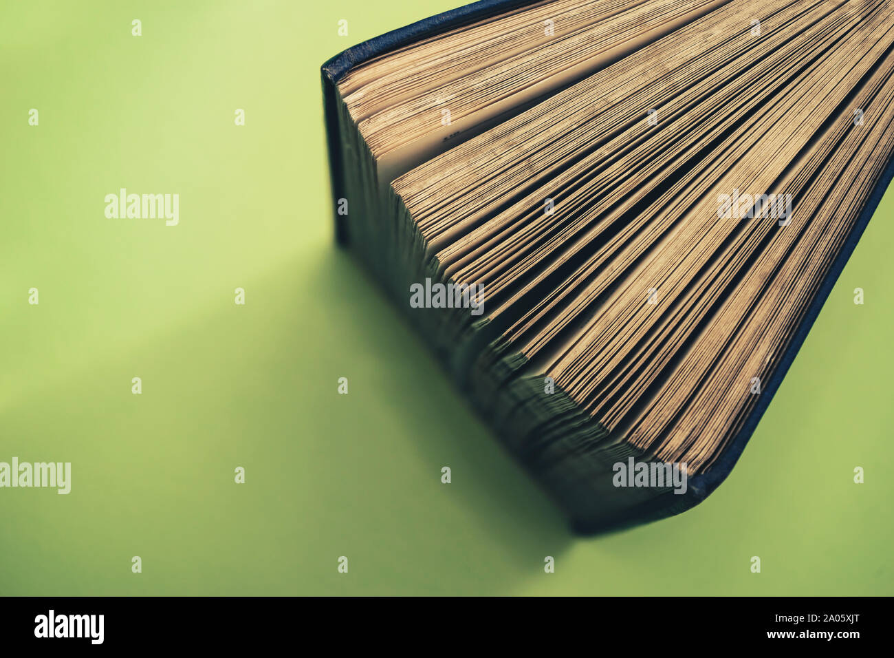 Close up Beautiful open old book top view on a green background table ...