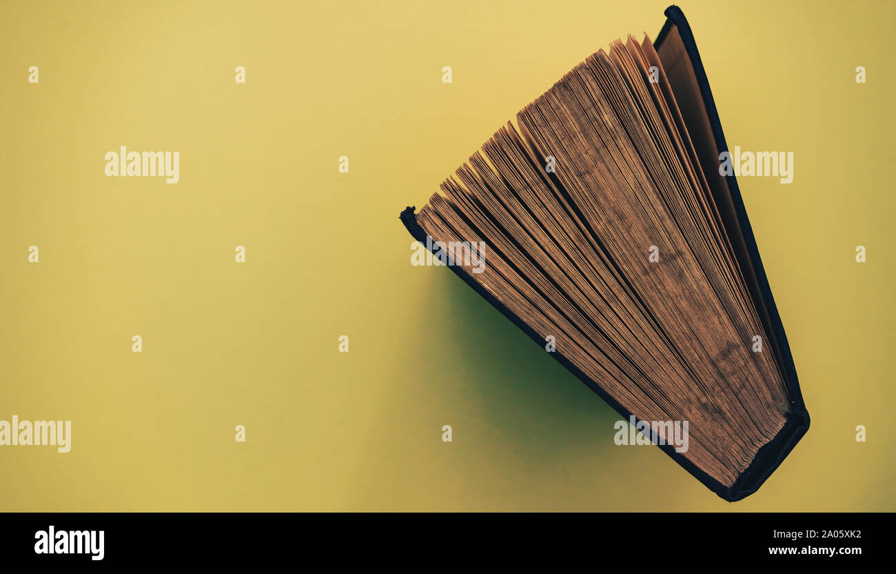 Beautiful open old book top view on a yellow background table Stock ...