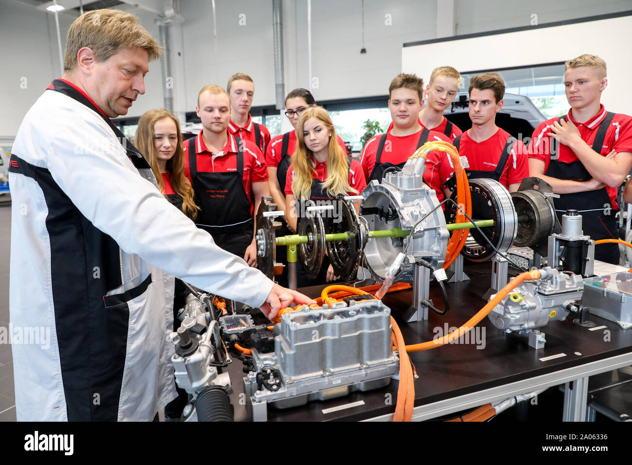 Car mechatronics technician explains on the computer the car diagnostic ...