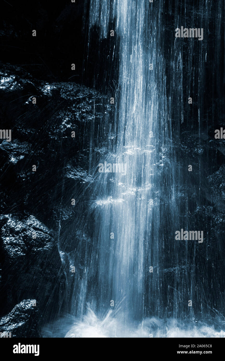 running water abstract, small waterfall over dark rock, toned Stock ...