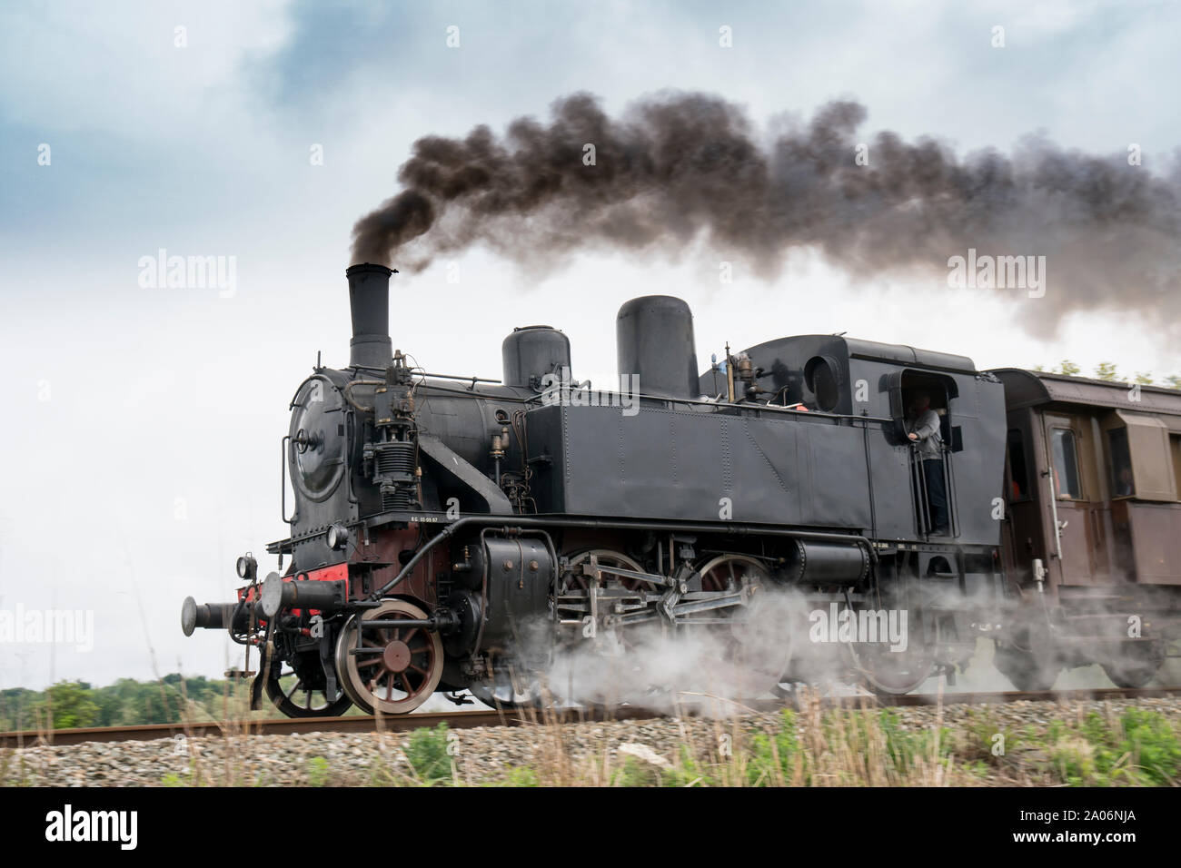 Vintage steam train with ancient locomotive and old carriages runs on ...