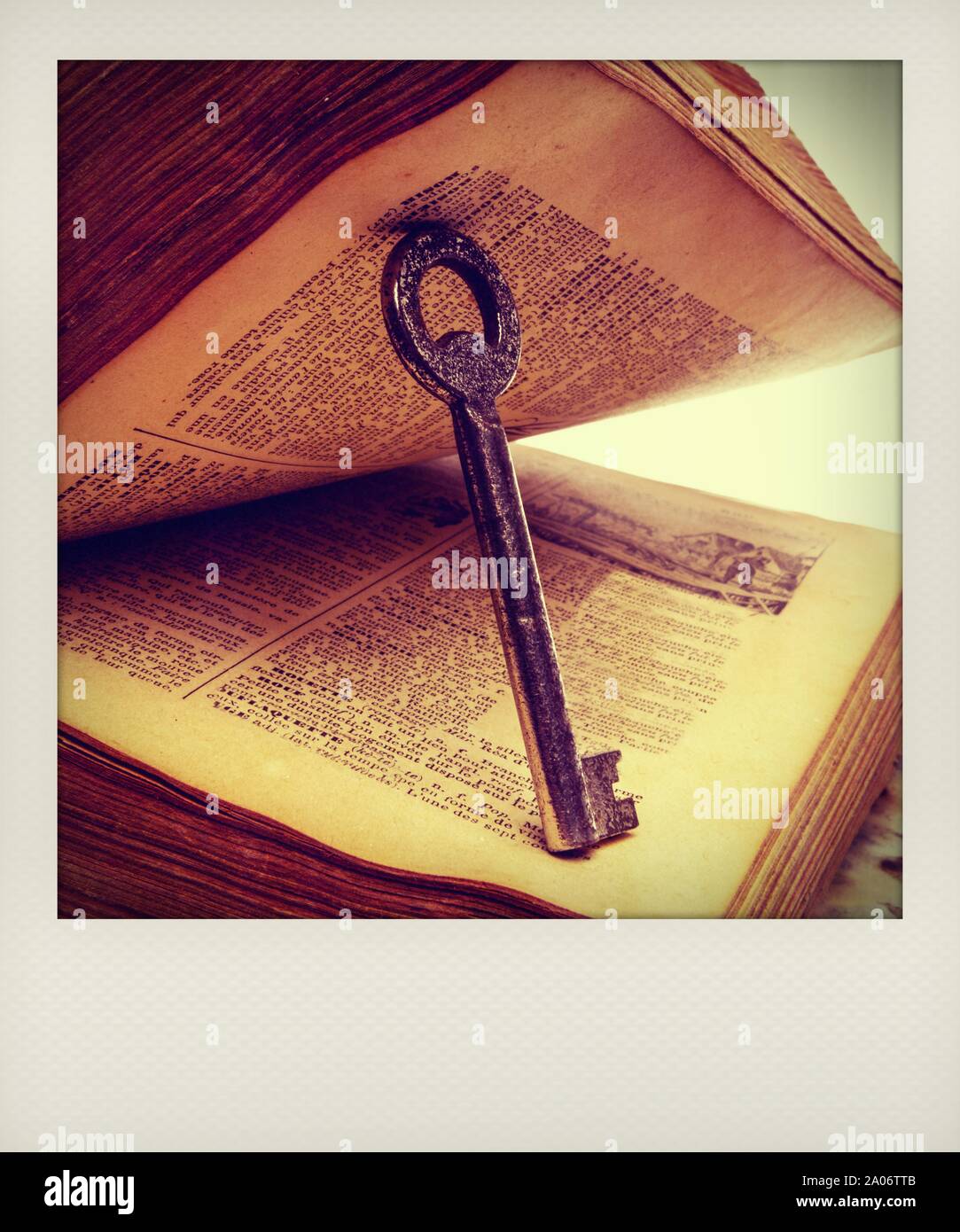 Key to knowledge concept. Key on a vintage book Stock Photo - Alamy