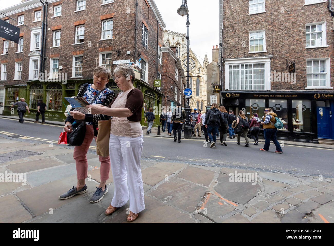 York street scene with two female tourists with city map Stock Photo ...