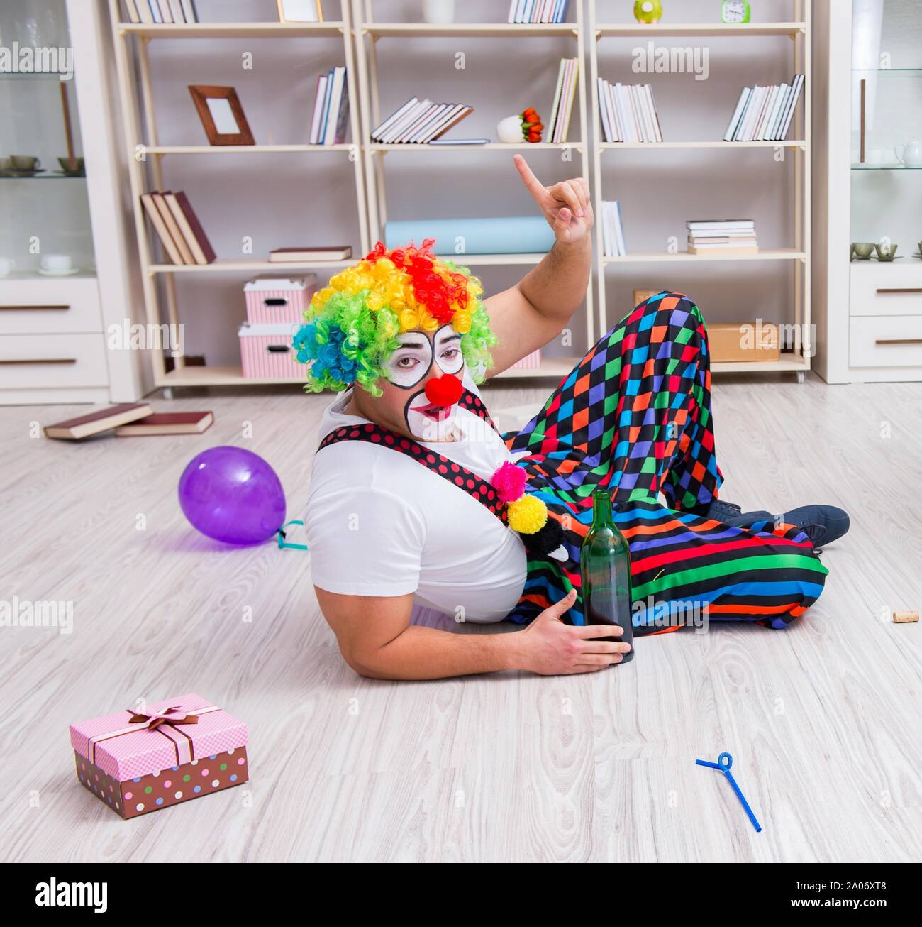 The drunk clown celebrating having a party at home Stock Photo - Alamy