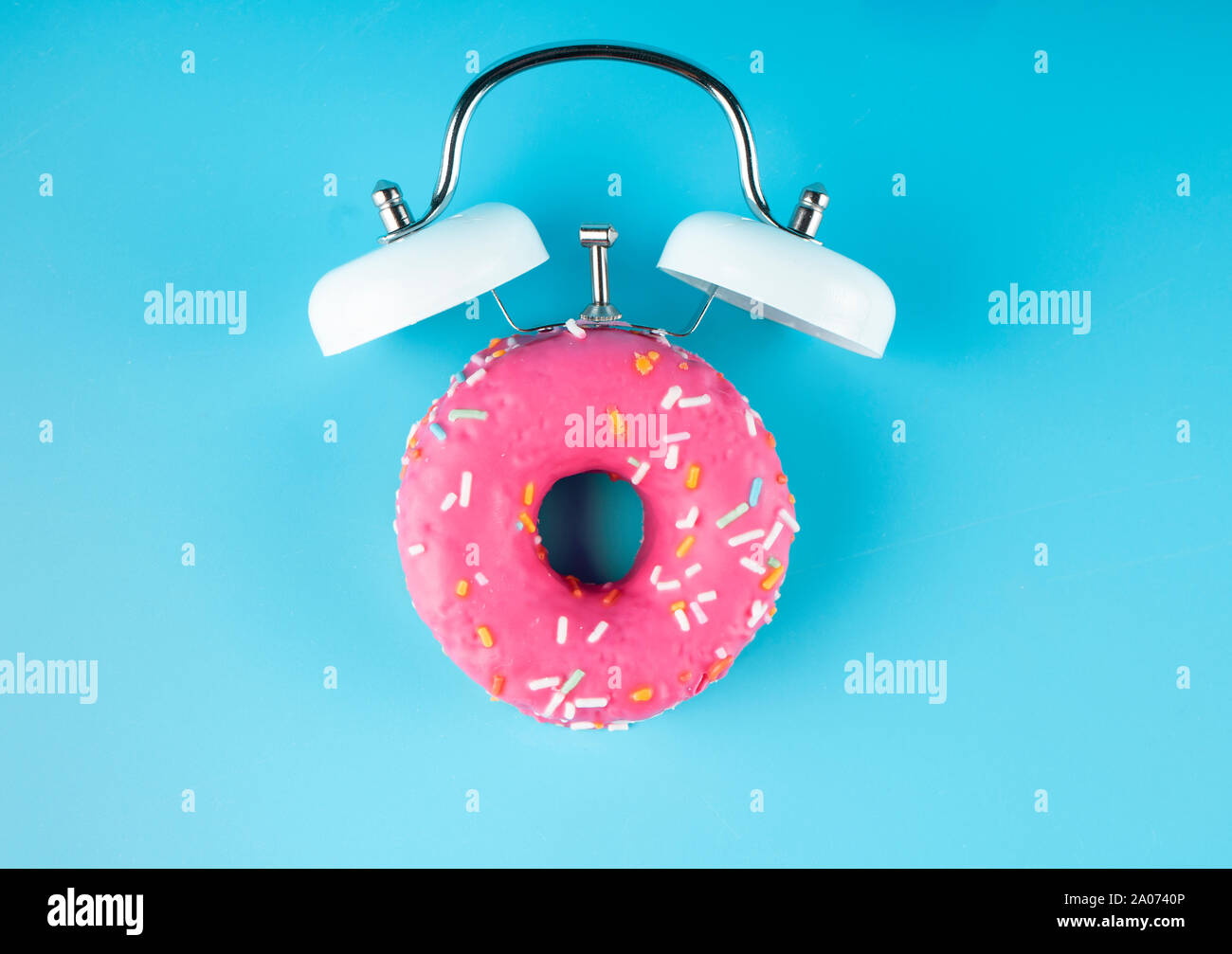 Donuts glaze with alarm clock alarm on blue background. Donuts alarm ...