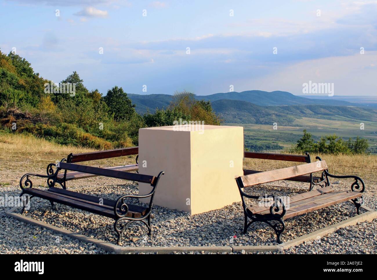 Lookout point with wooden benches on top of the mountain in Romania ...