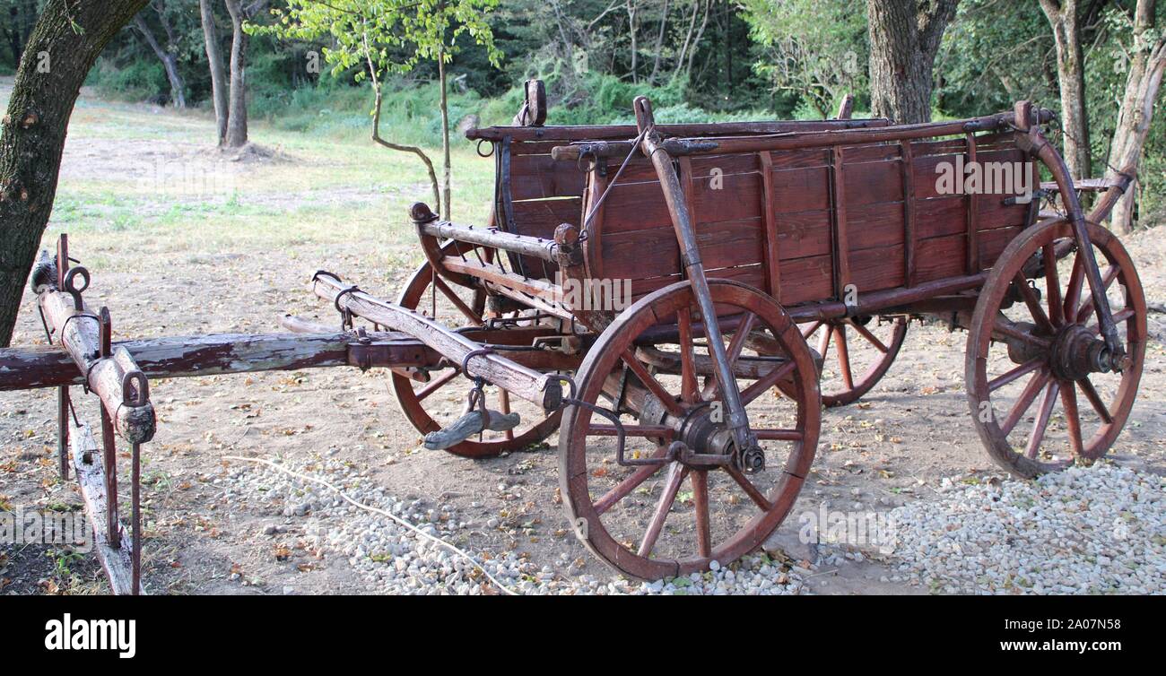 Old wooden float that used to be pulled by oxen , located next to a ...