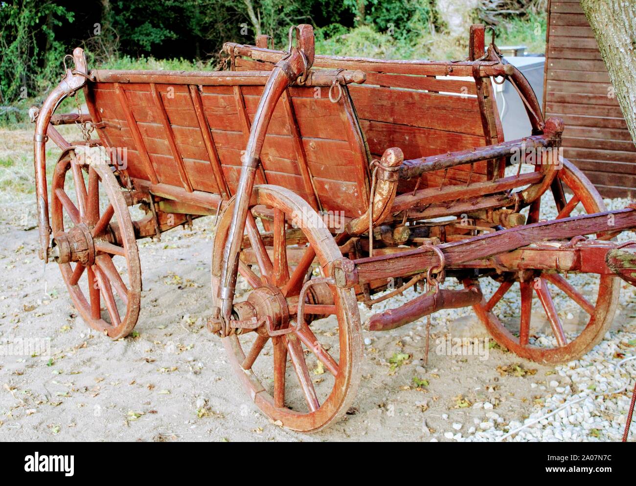 Old wooden float that used to be pulled by oxen , located next to a ...