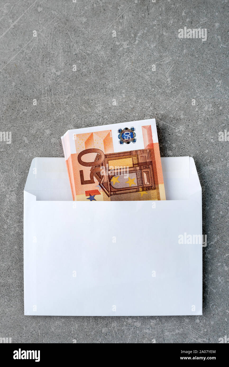 White envelope with a 50 euro bills. Stack of fifty euro notes in open ...