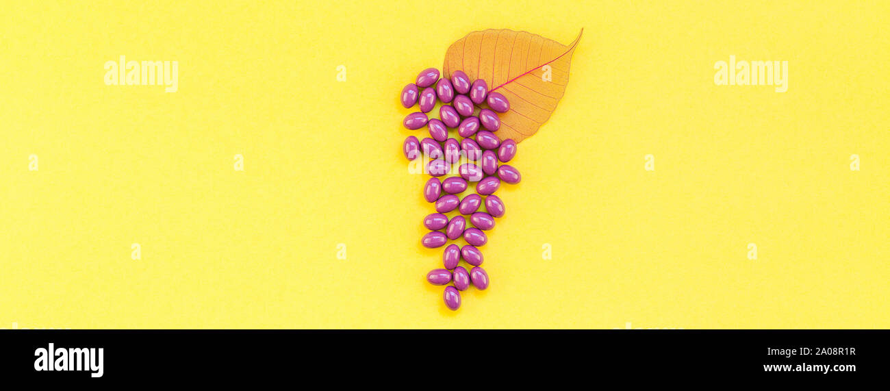Purple nutritional supplement Grape seed extract pills in bunch of ...